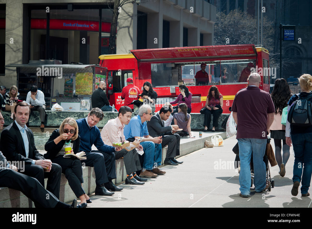 Office workers eat lunch in front of the Seagram building on Park ...