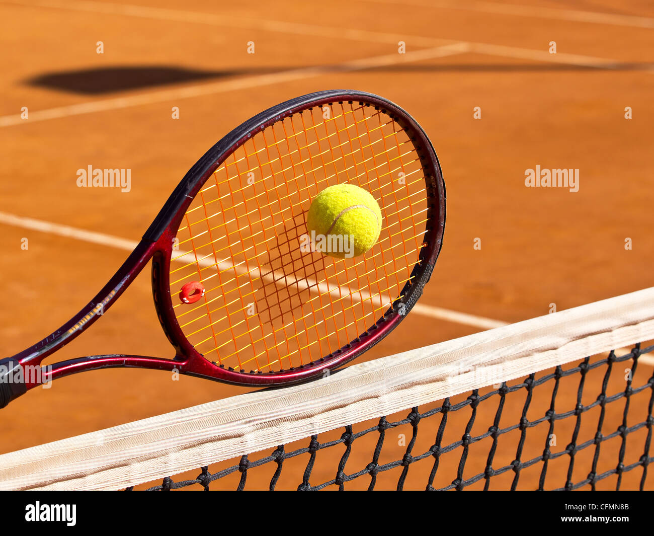 tennis racquet on the net in the middle of the tennis court Stock Photo ...