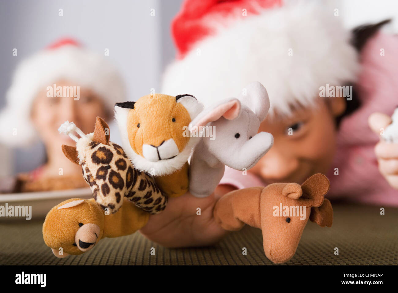 USA, California, Los Angeles, Girl wearing Santa hat playing with ...