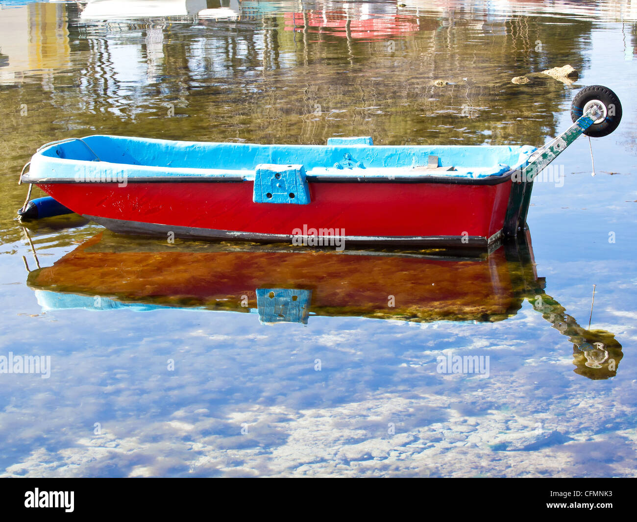 funny small red boat with car tyre Stock Photo - Alamy
