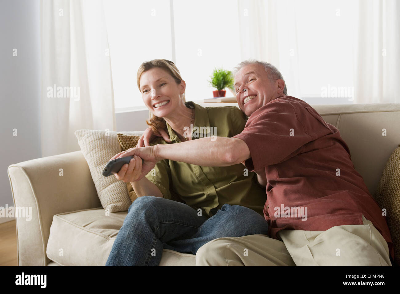 Fighting for the tv remote hi-res stock photography and images - Alamy