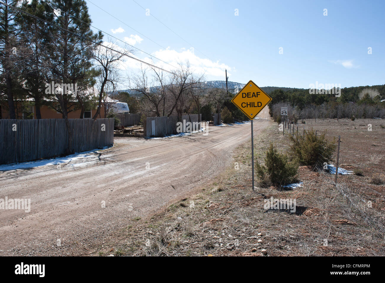 Sign on a dirt road warning to use extra caution when driving because a ...