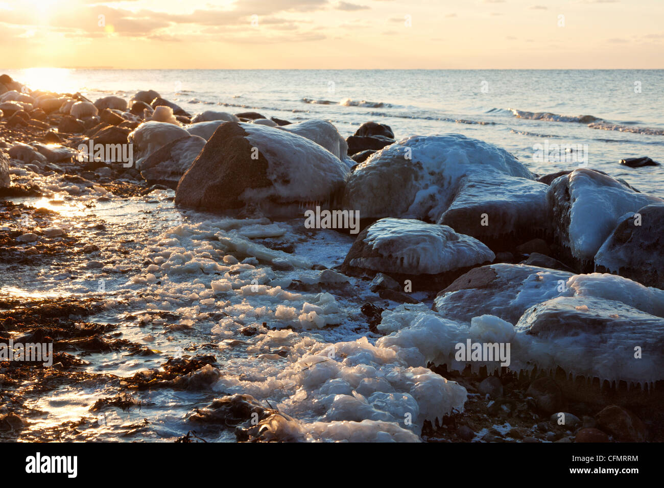 Frozen rocks at the baltic sea coast of Fehmarn at sunset Stock Photo ...