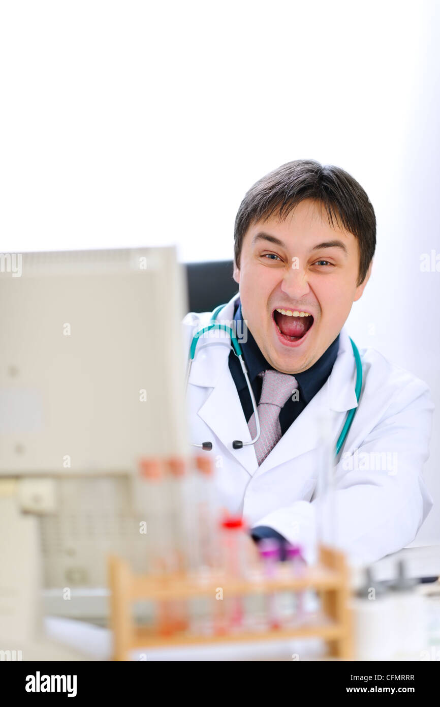 Extremely happy medical doctor working on computer Stock Photo - Alamy