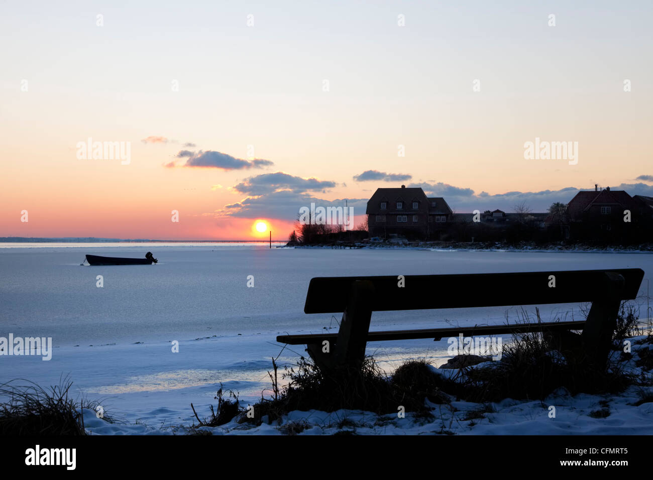 Bench with a view over the bay of Lemkenhafen, Fehmarn at sunset, a ...