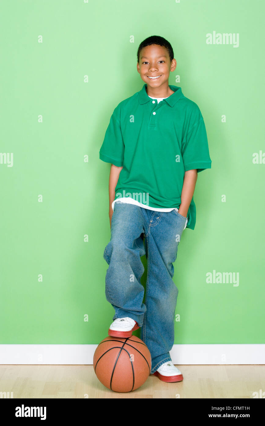 Studio portrait of teenage boy with basketball Stock Photo - Alamy