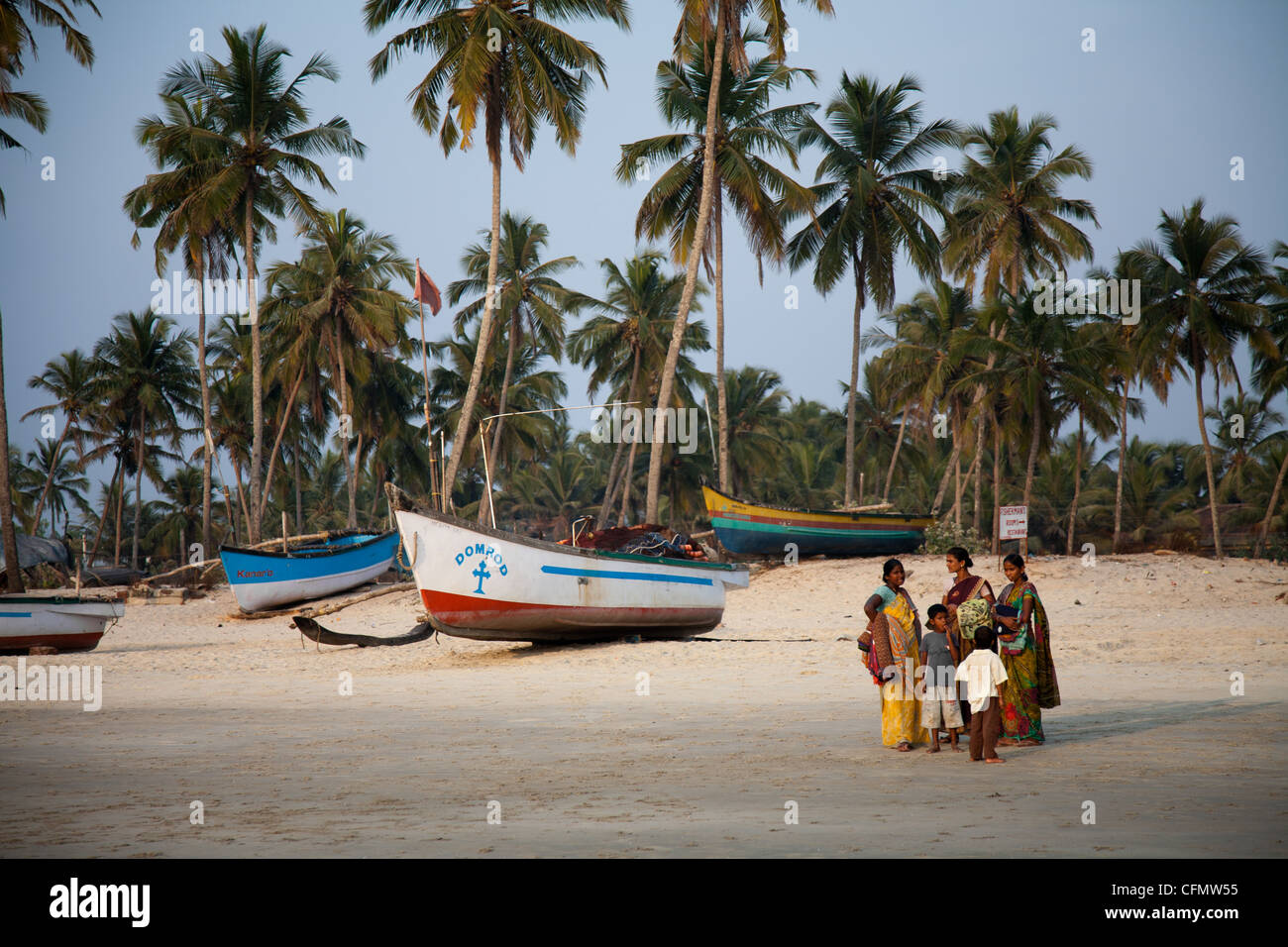 Palm trees and fishing boats on Colva Beach in India Stock Photo - Alamy