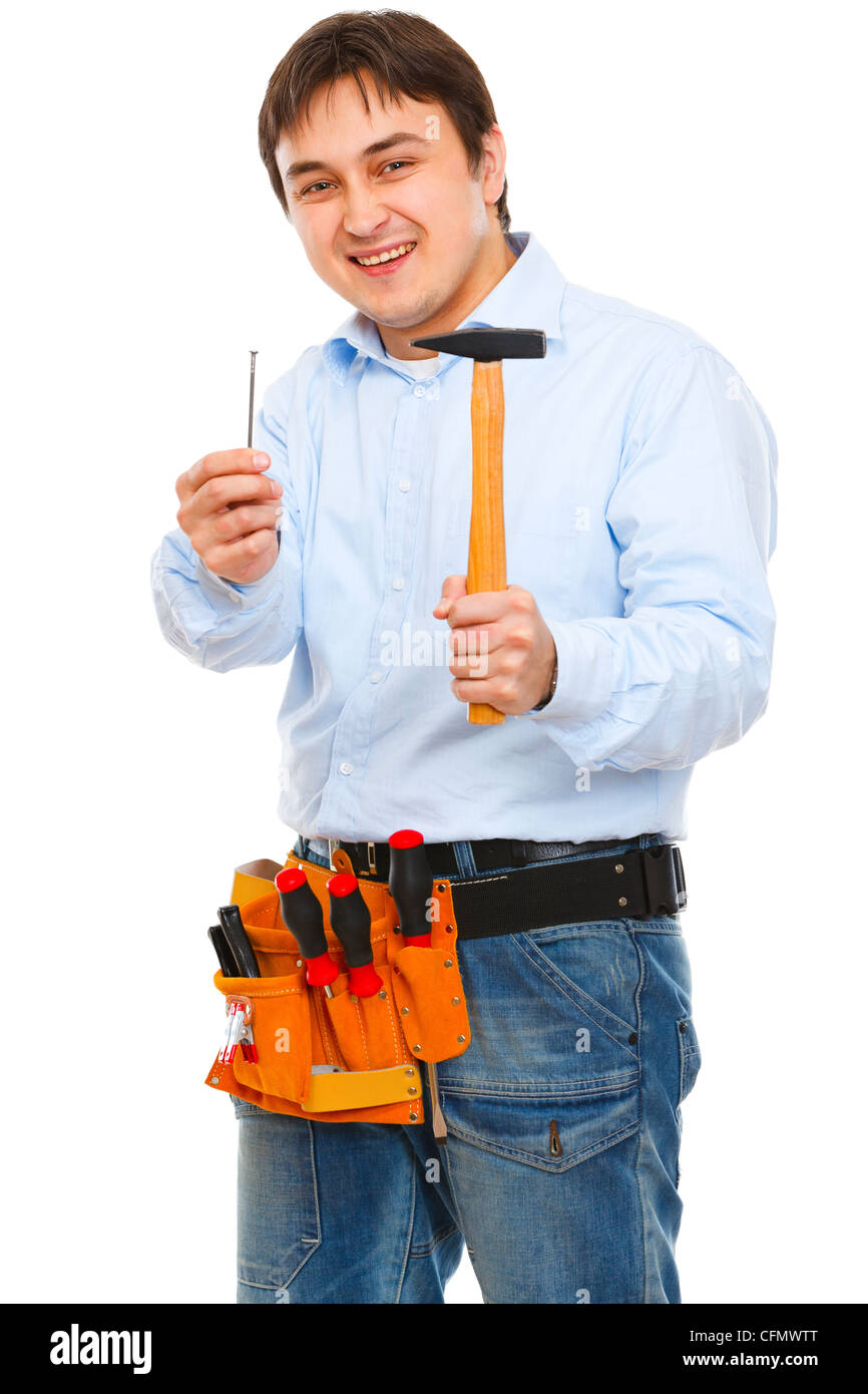 Smiling construction stretching hammer and nail Stock Photo - Alamy