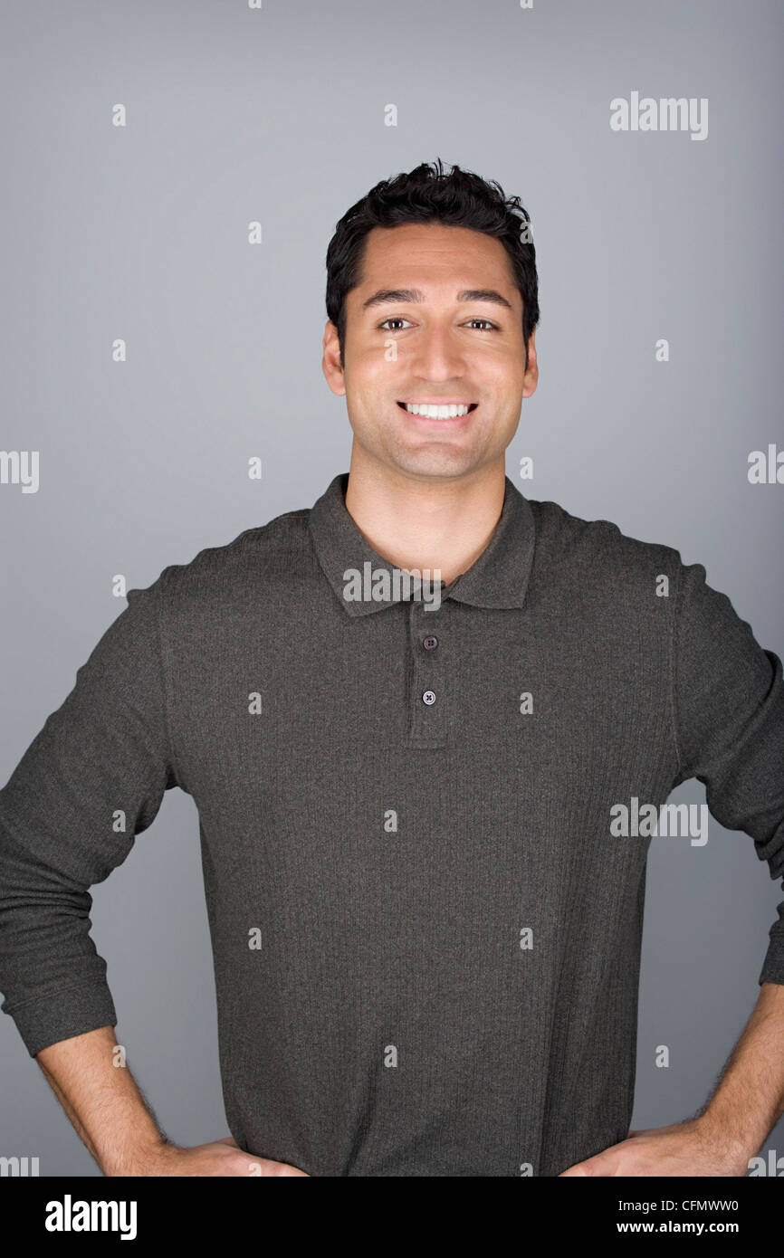 Studio shot portrait of mid adult man with hands on hip, waist up Stock ...