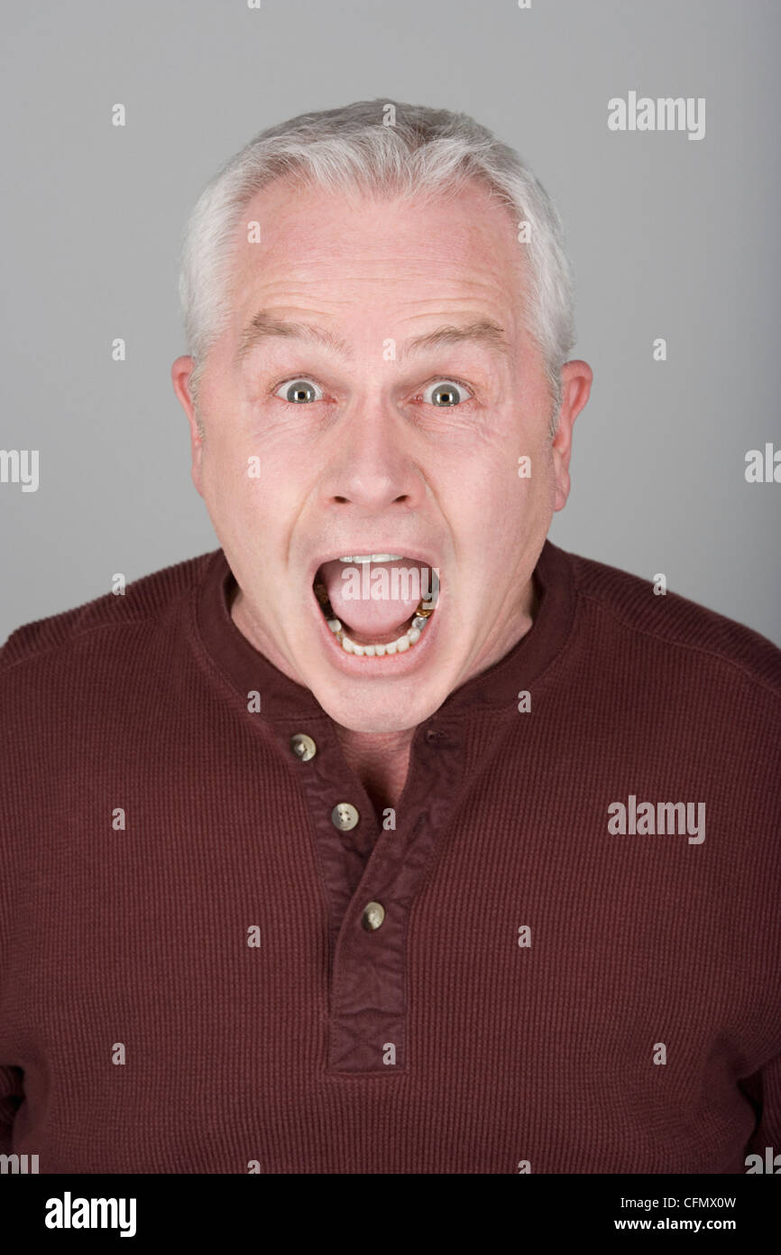 Studio portrait of scared senior man Stock Photo - Alamy