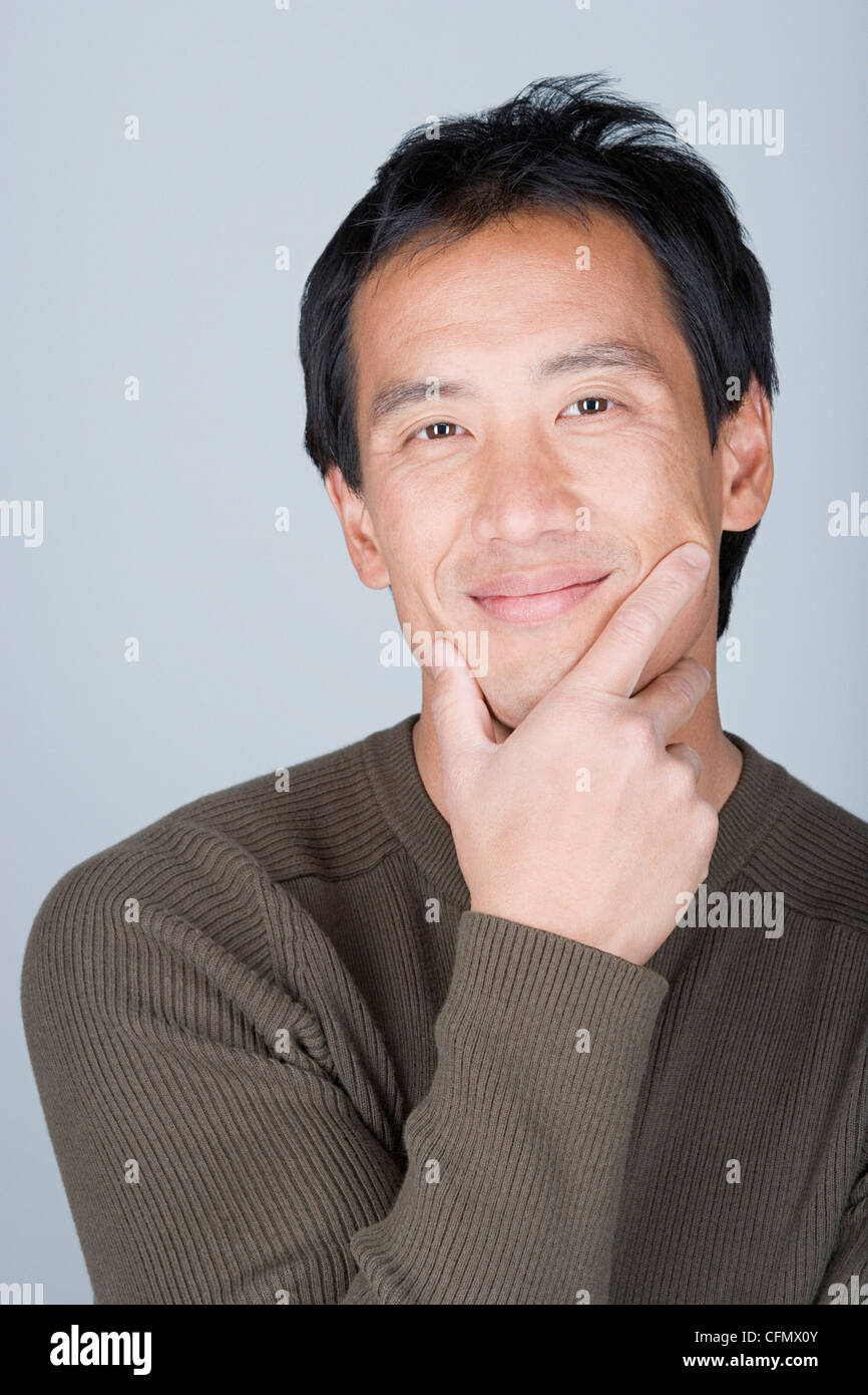 Studio portrait of happy Asian man Stock Photo - Alamy
