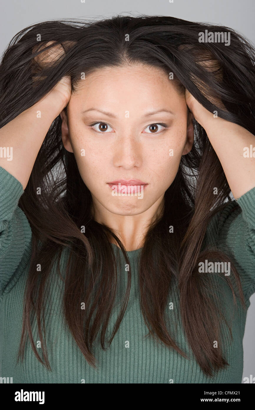 Studio portrait of stressed Chinese woman Stock Photo - Alamy