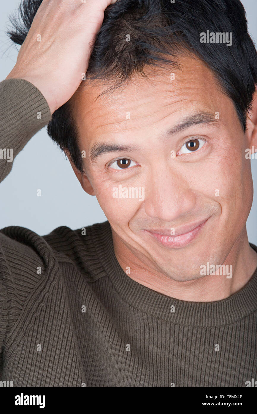 Studio portrait of happy Asian man Stock Photo - Alamy