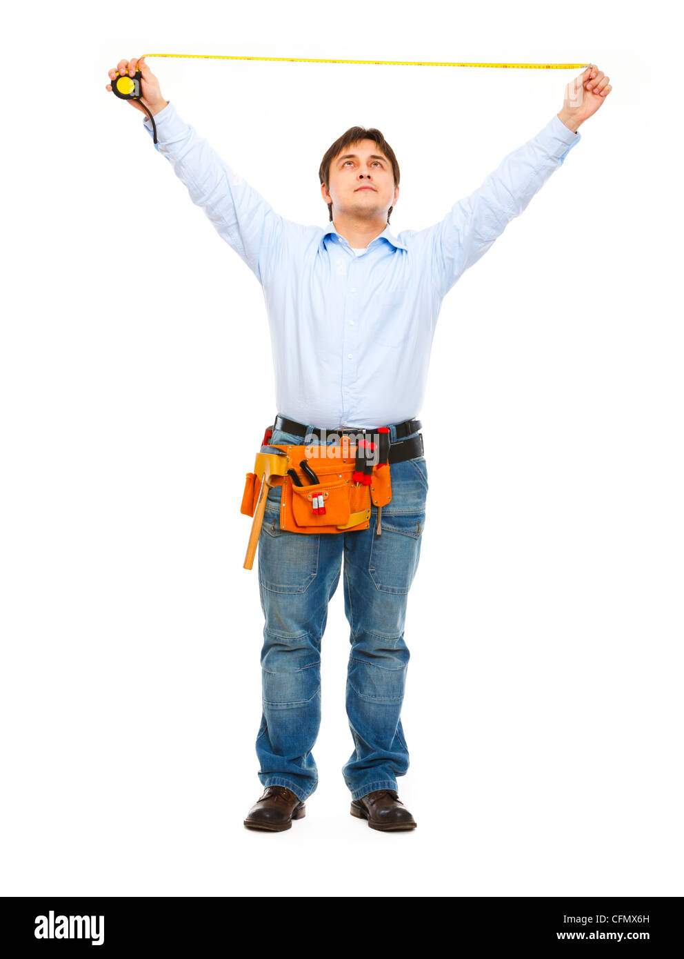 Construction worker measuring with ruler Stock Photo - Alamy