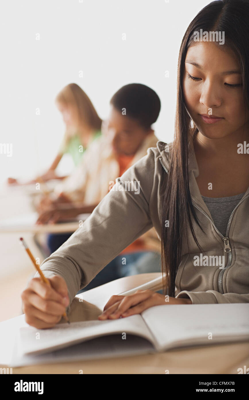USA, California, Los Angeles, School kid writing in their copybooks ...
