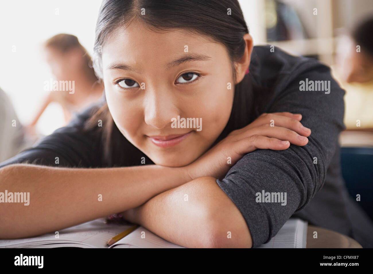 USA, California, Los Angeles, Girl leaning on desk in classroom Stock ...