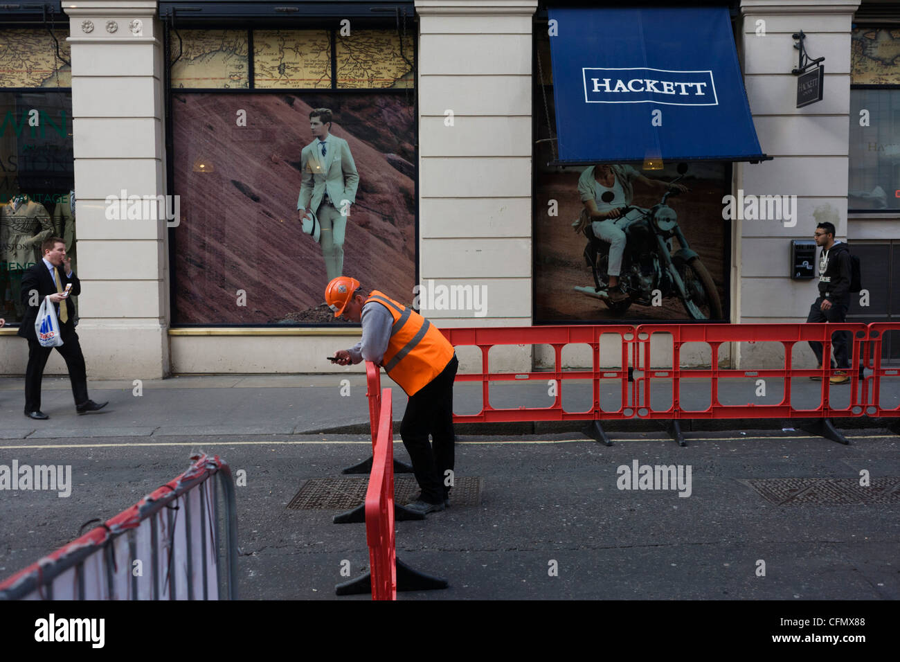Construction worker outside the mens' clothing outfitters Hackett in ...