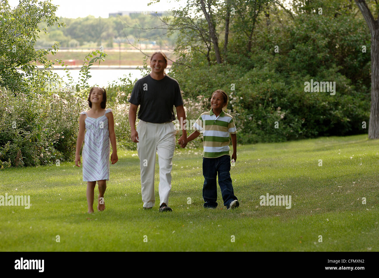 Father and Children Walking in Park Stock Photo - Alamy