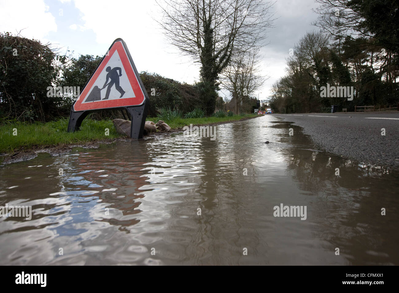 Water running down a road from a burst water pipe during the drought of ...