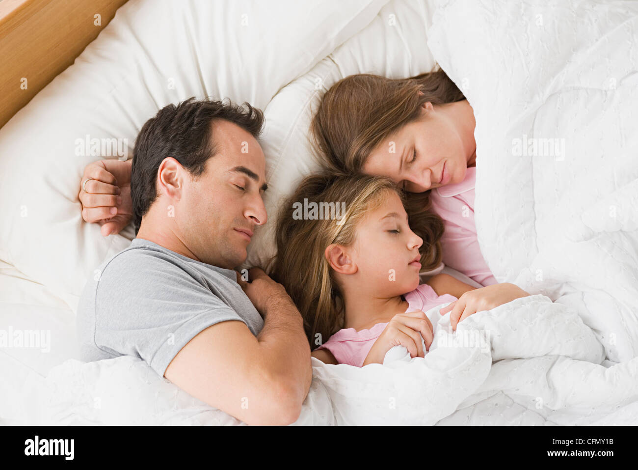 Family of three people sleeping in one bed hi-res stock photography and ...