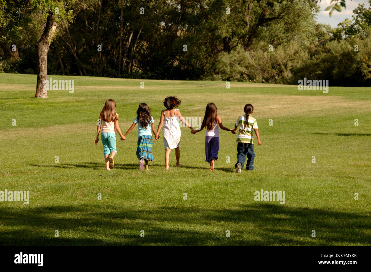 Group of Children Walking in Park Stock Photo - Alamy