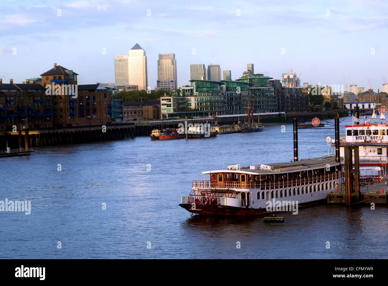 Transport in the Thames with Canary Warf as background Stock Photo - Alamy