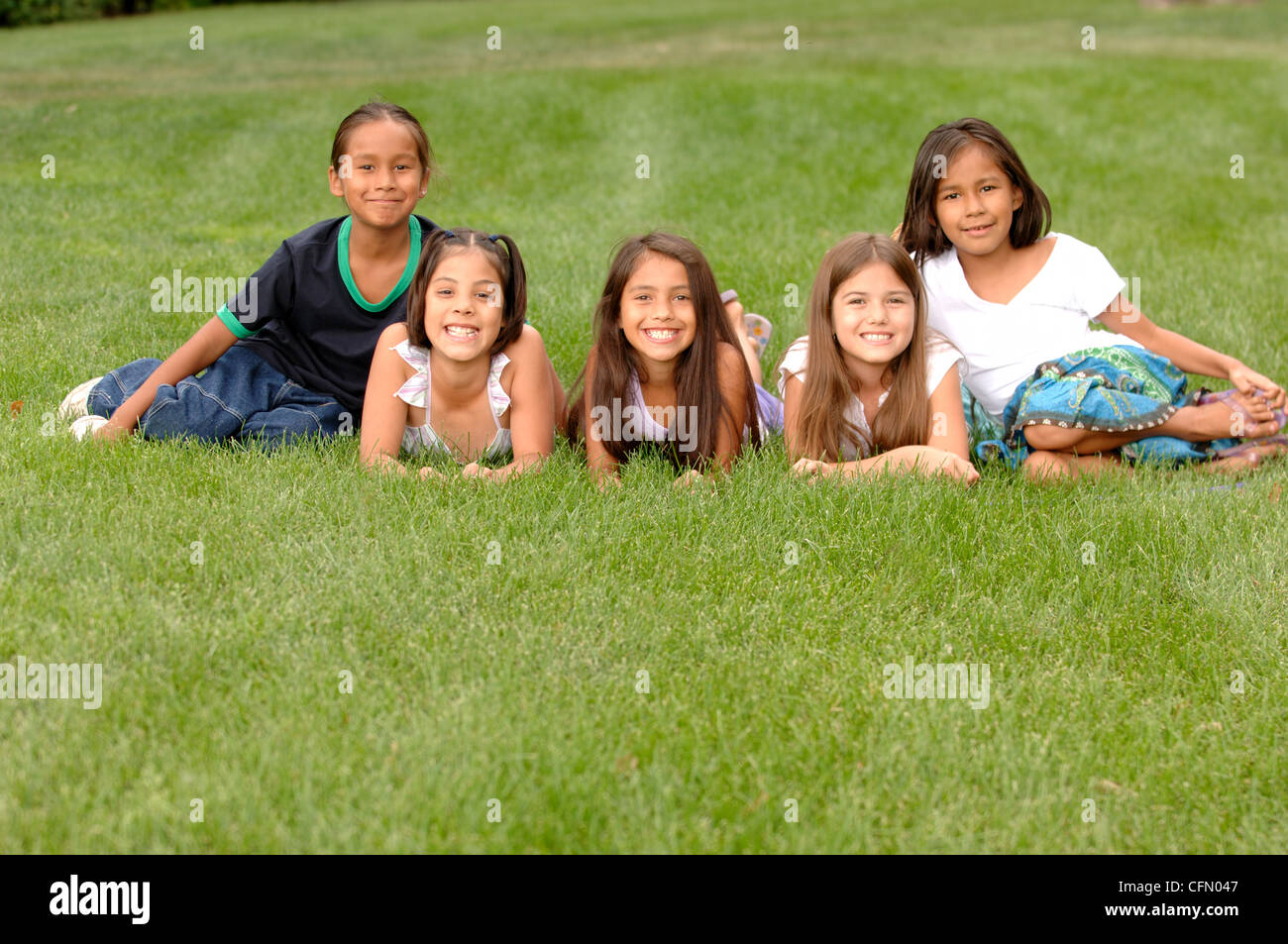 Group of Kids on Grass Stock Photo - Alamy