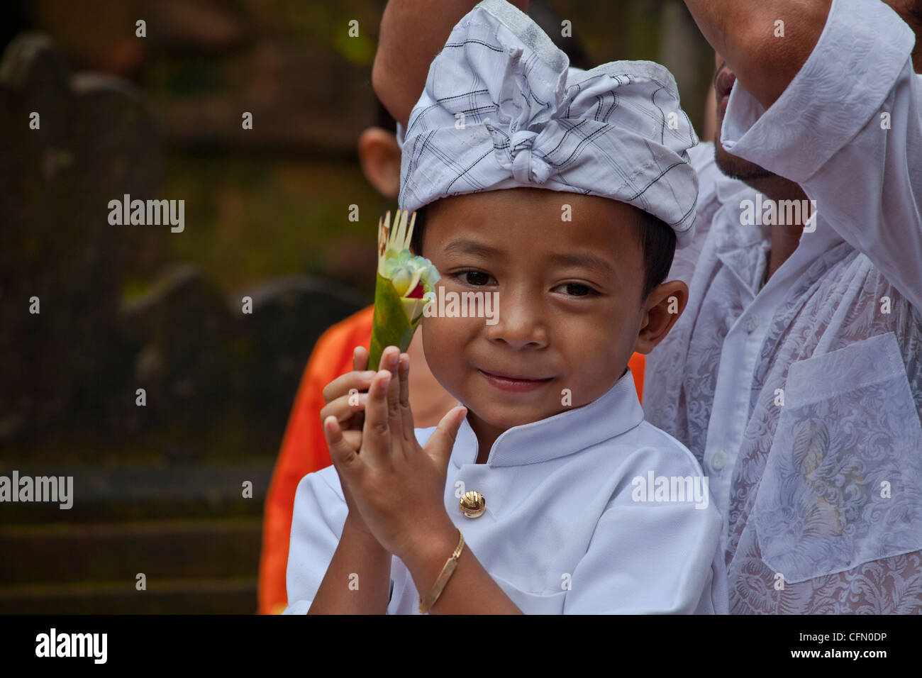 Young boy in traditional clothes at a religious ceremony in Bali, South ...