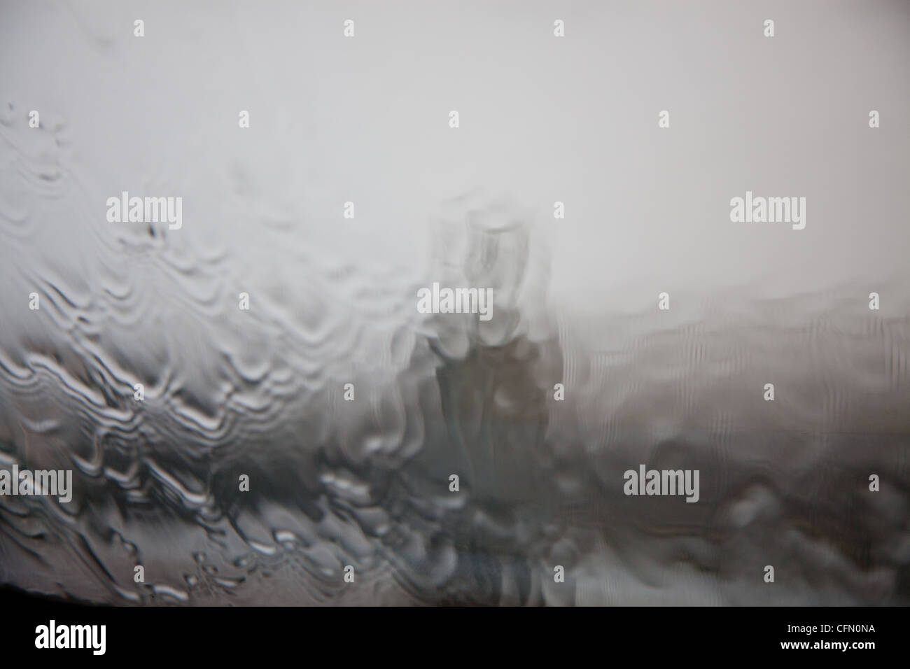 person standing outside with rain on glass window Stock Photo - Alamy