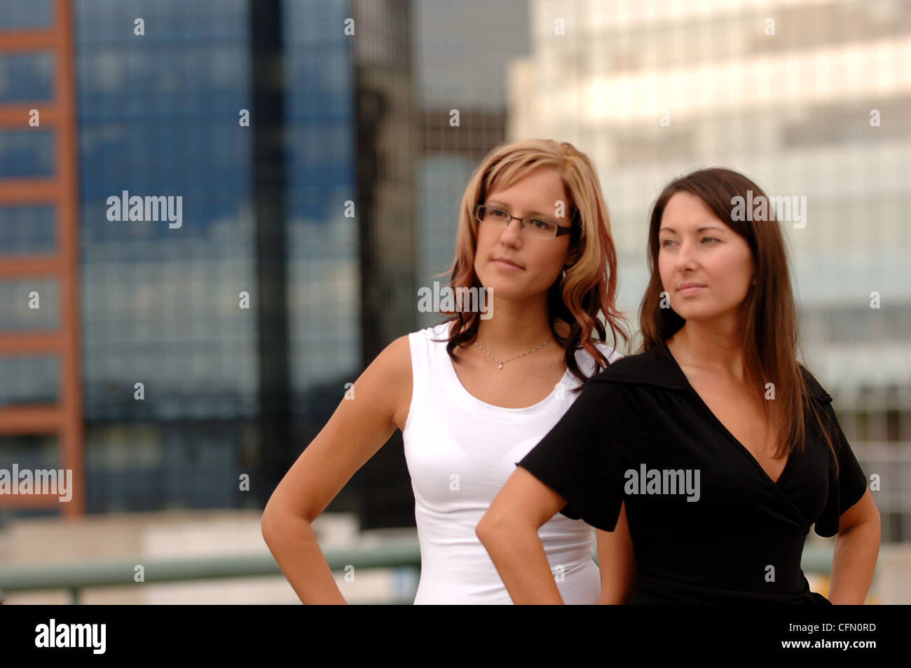 Women Outside with Cityscape in Background Stock Photo - Alamy