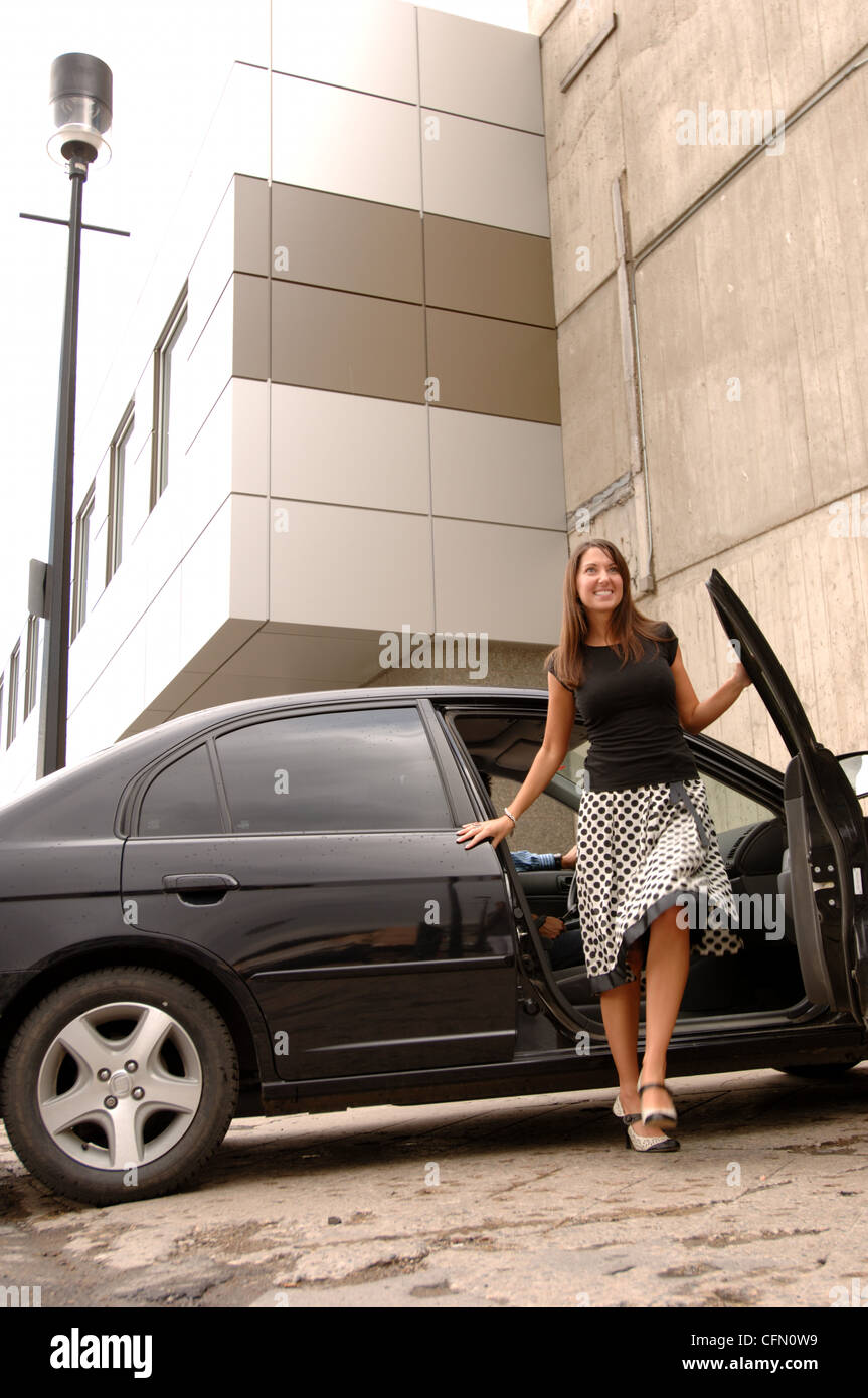 Woman Getting Out of Car Stock Photo - Alamy