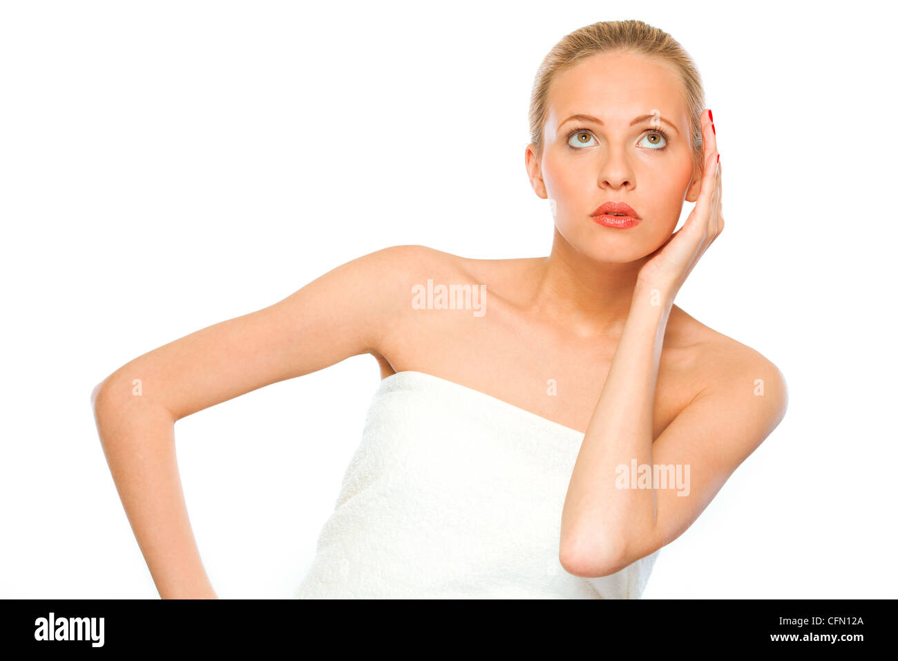 Beautiful woman with hand near face looking up at copy space isolated ...