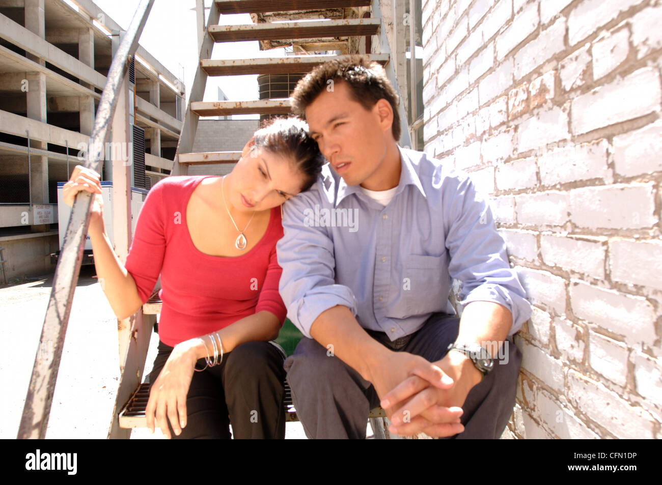 Couple Sitting on Fire Escape Stock Photo - Alamy