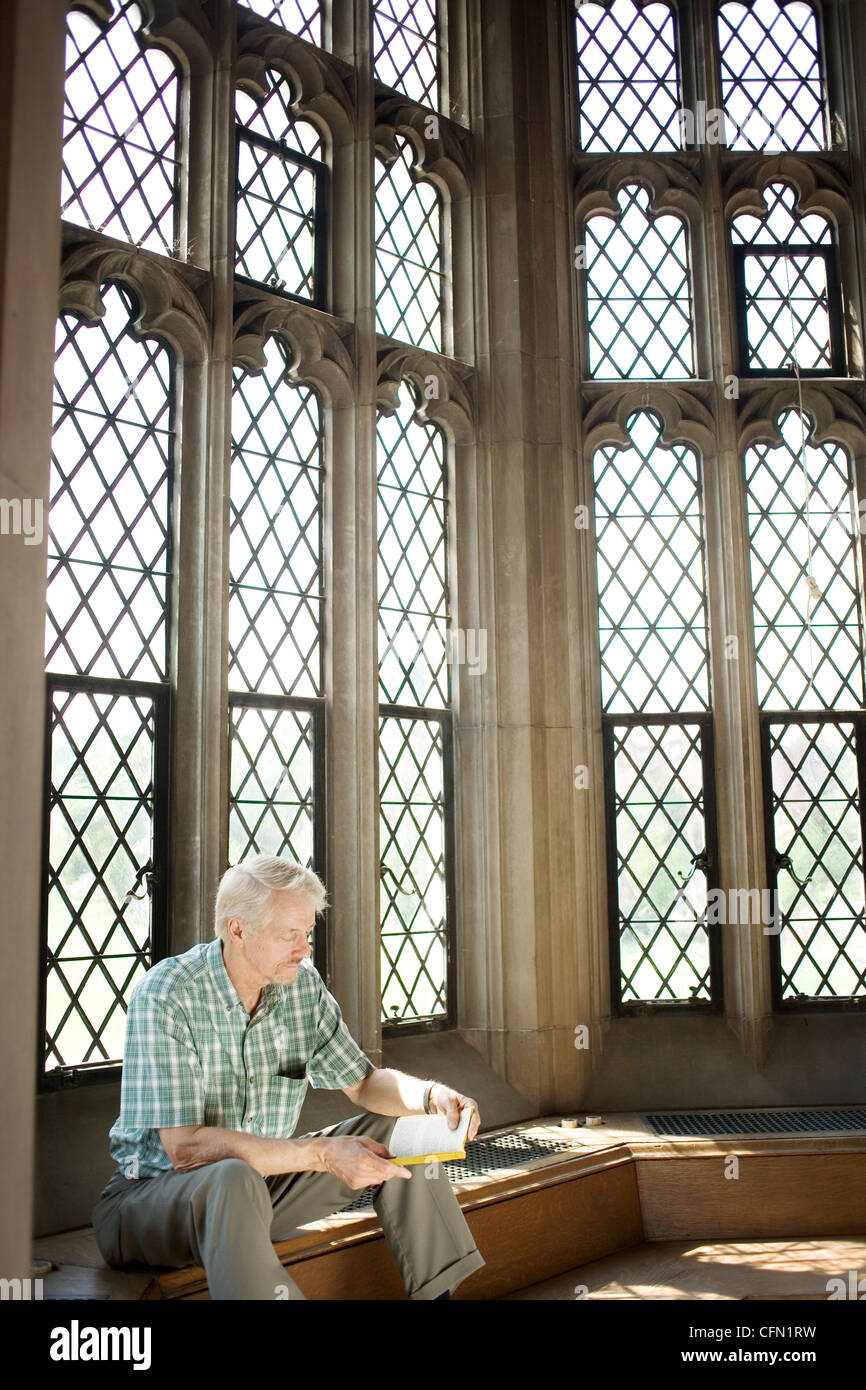 Teacher on Window Seat Reading Stock Photo - Alamy