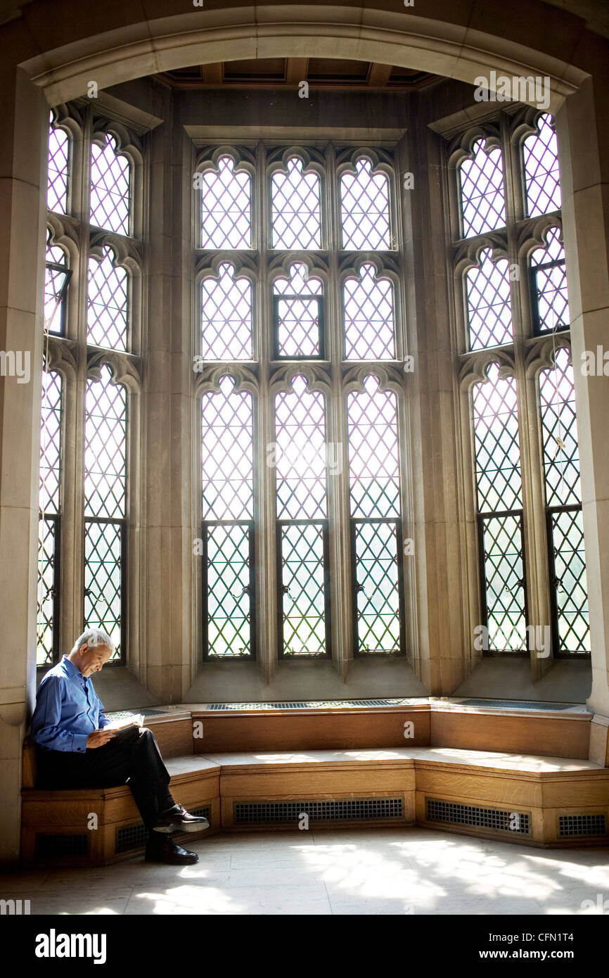 Teacher on Window Seat Reading Stock Photo - Alamy