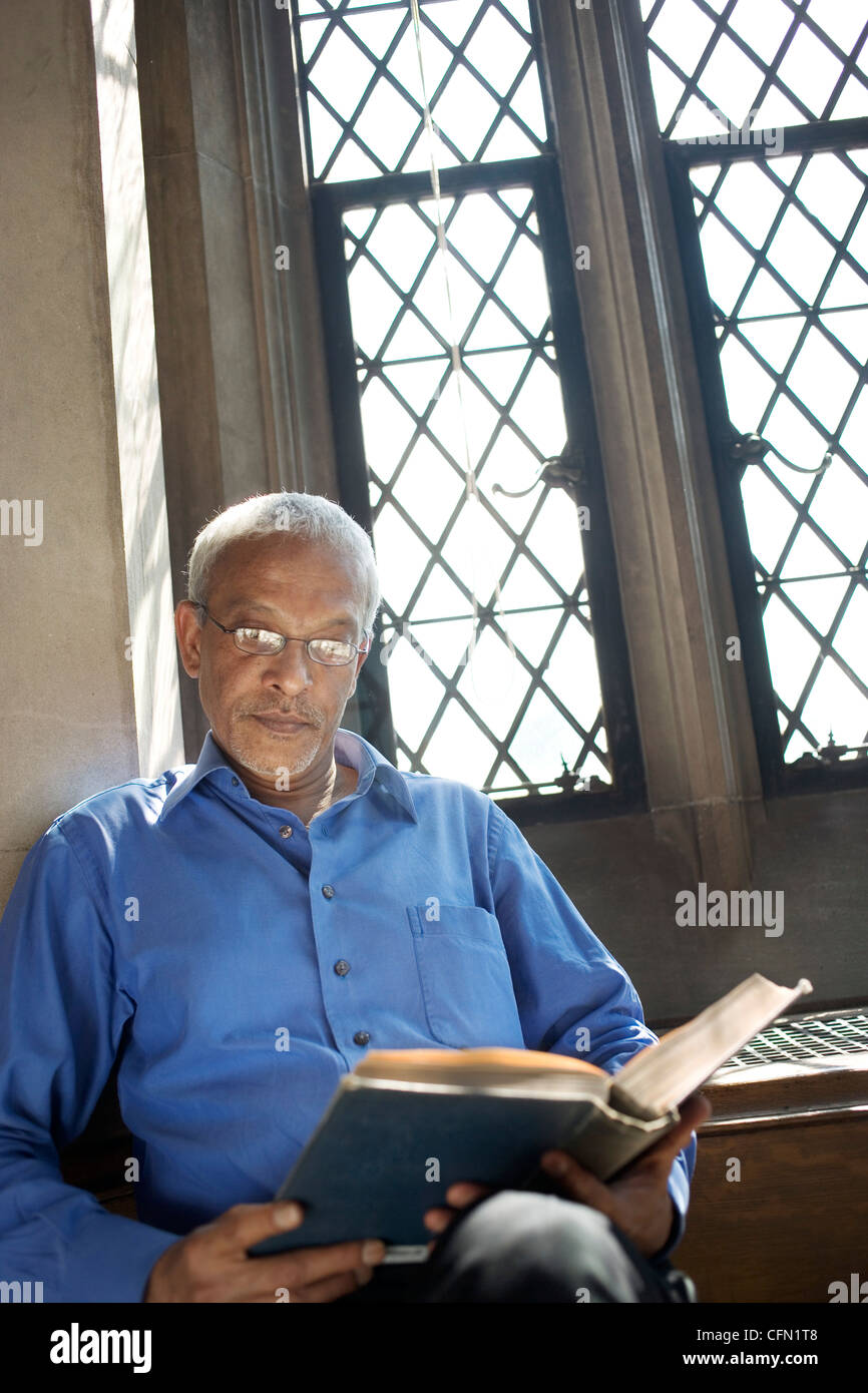 Teacher on Window Seat Reading Stock Photo - Alamy