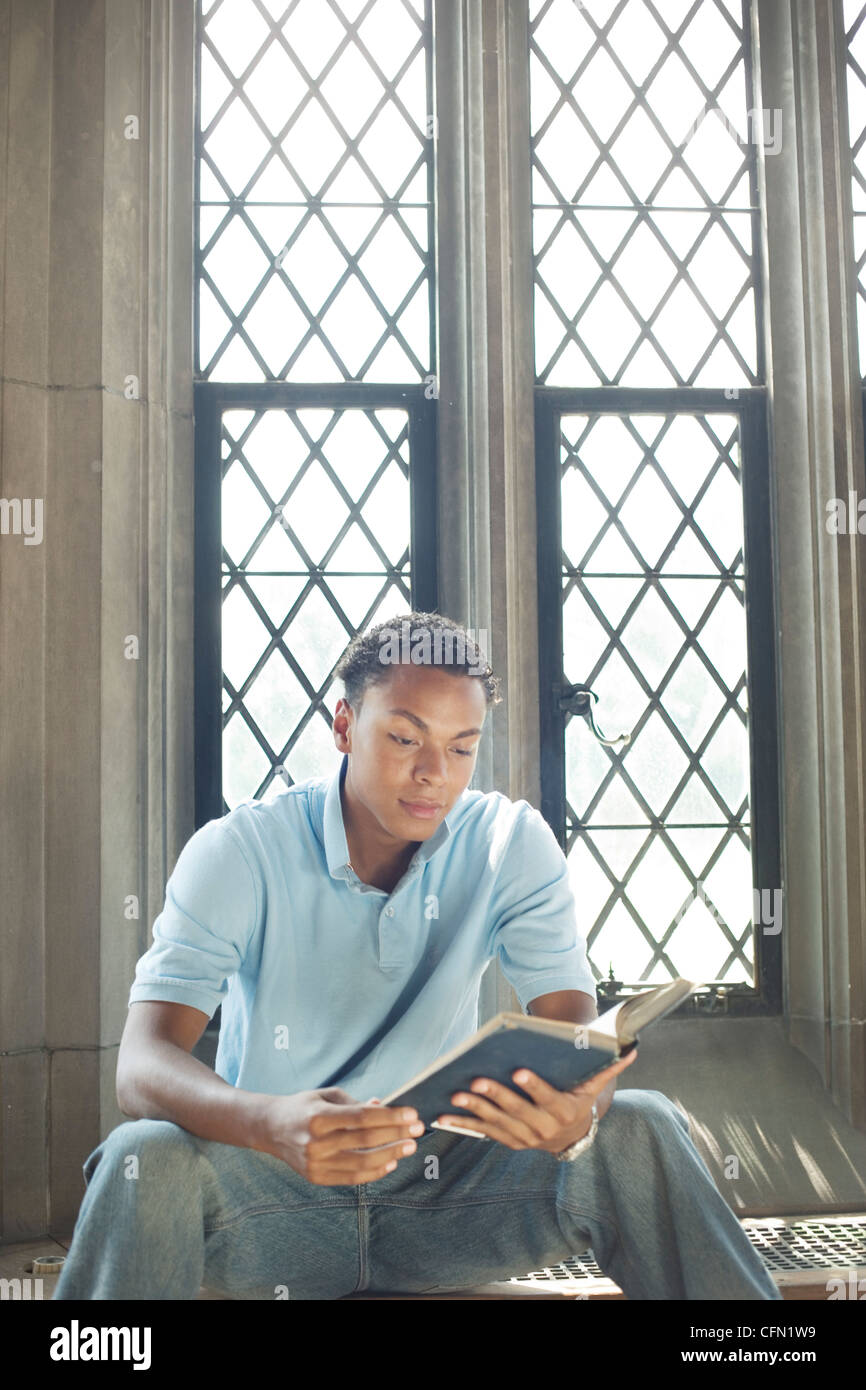 Student on Window Seat Reading Stock Photo - Alamy