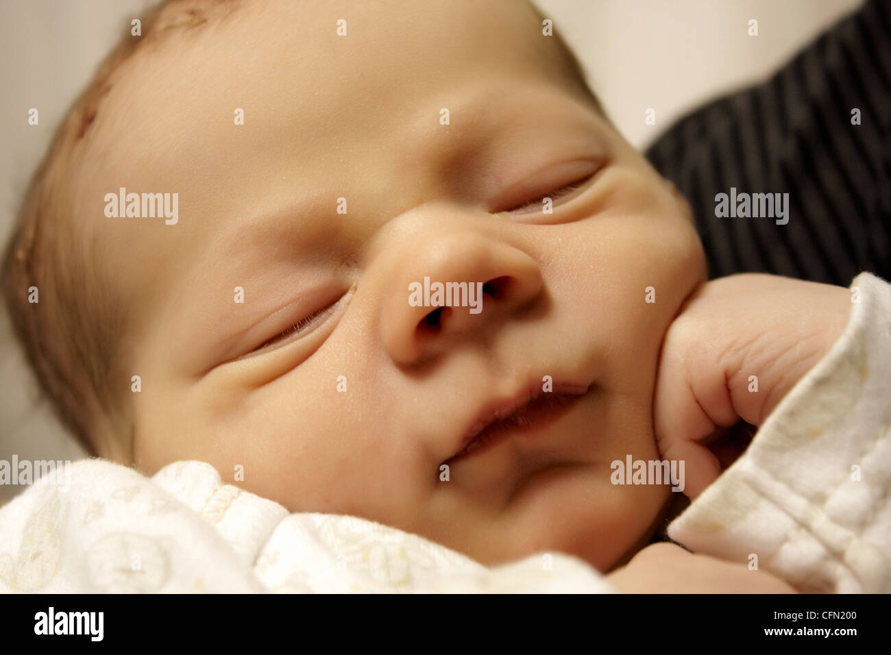 A new born baby being held closely Stock Photo - Alamy