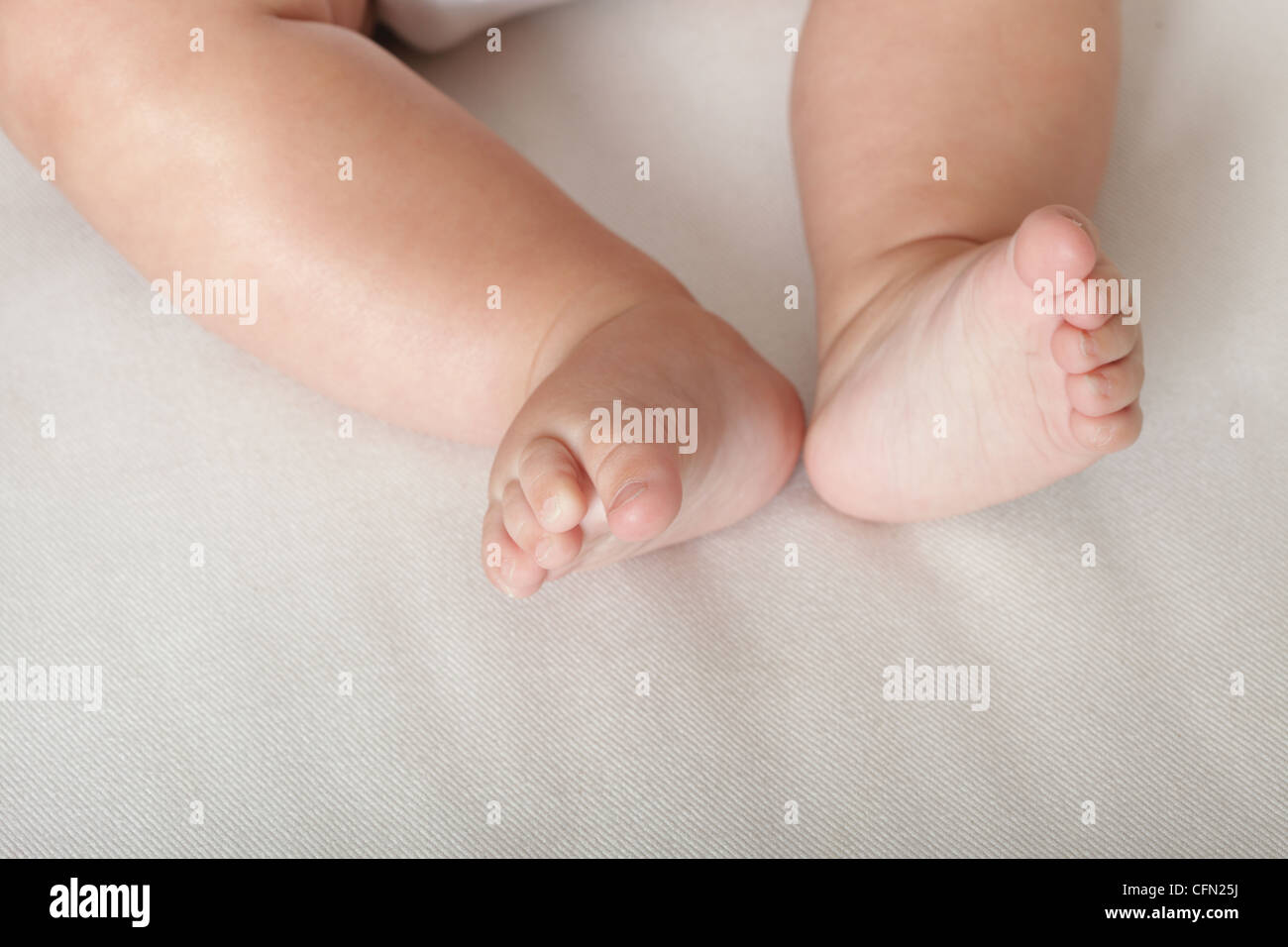 Baby small toe foot on white background Stock Photo - Alamy