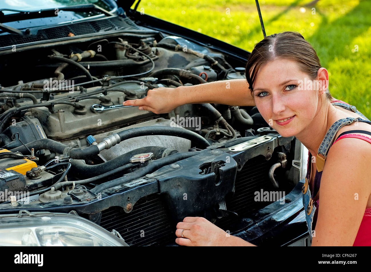 Young woman repairing her car Stock Photo - Alamy