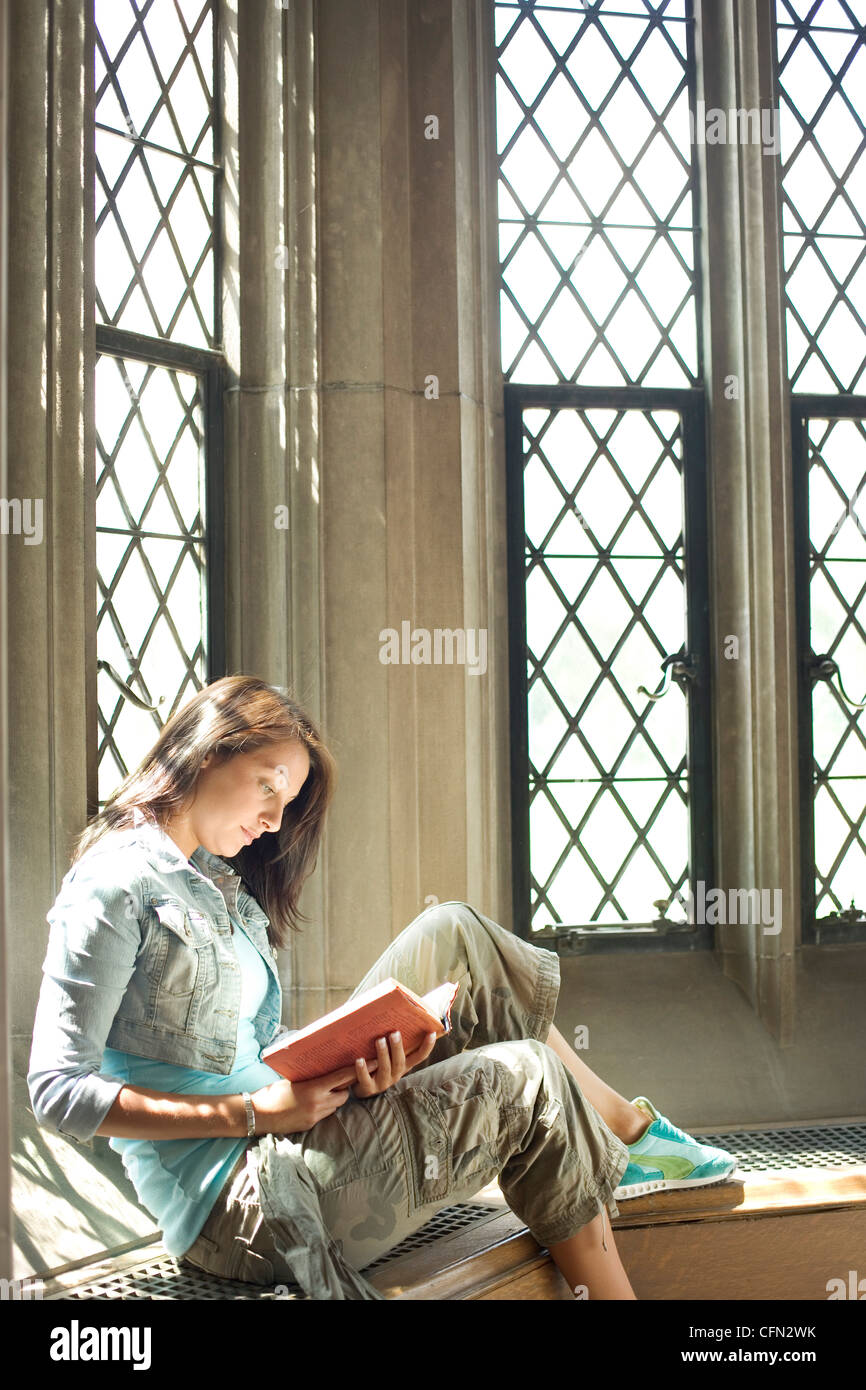 Student on Window Seat Reading Stock Photo - Alamy