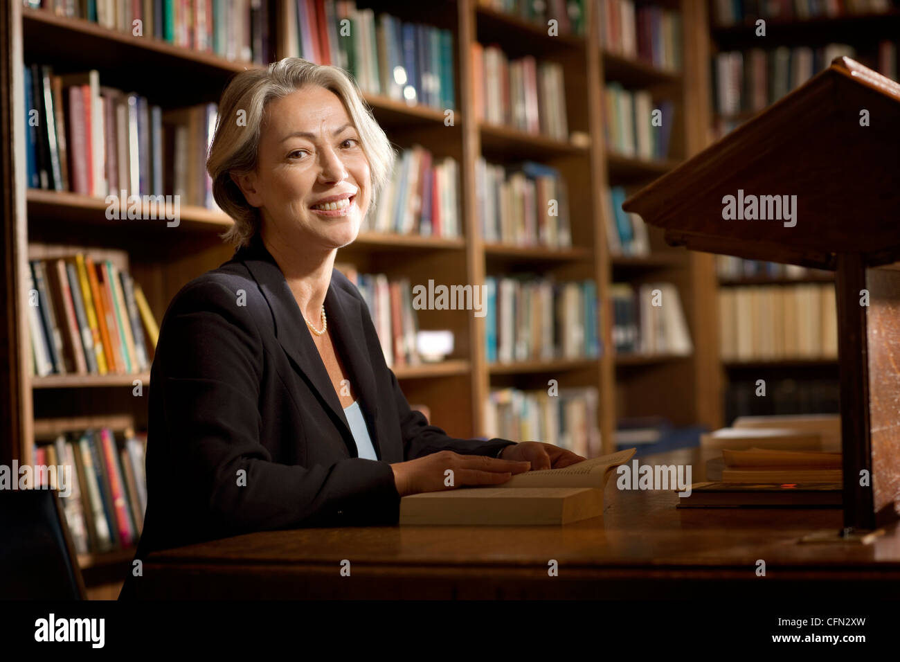 Teacher in Library Stock Photo - Alamy