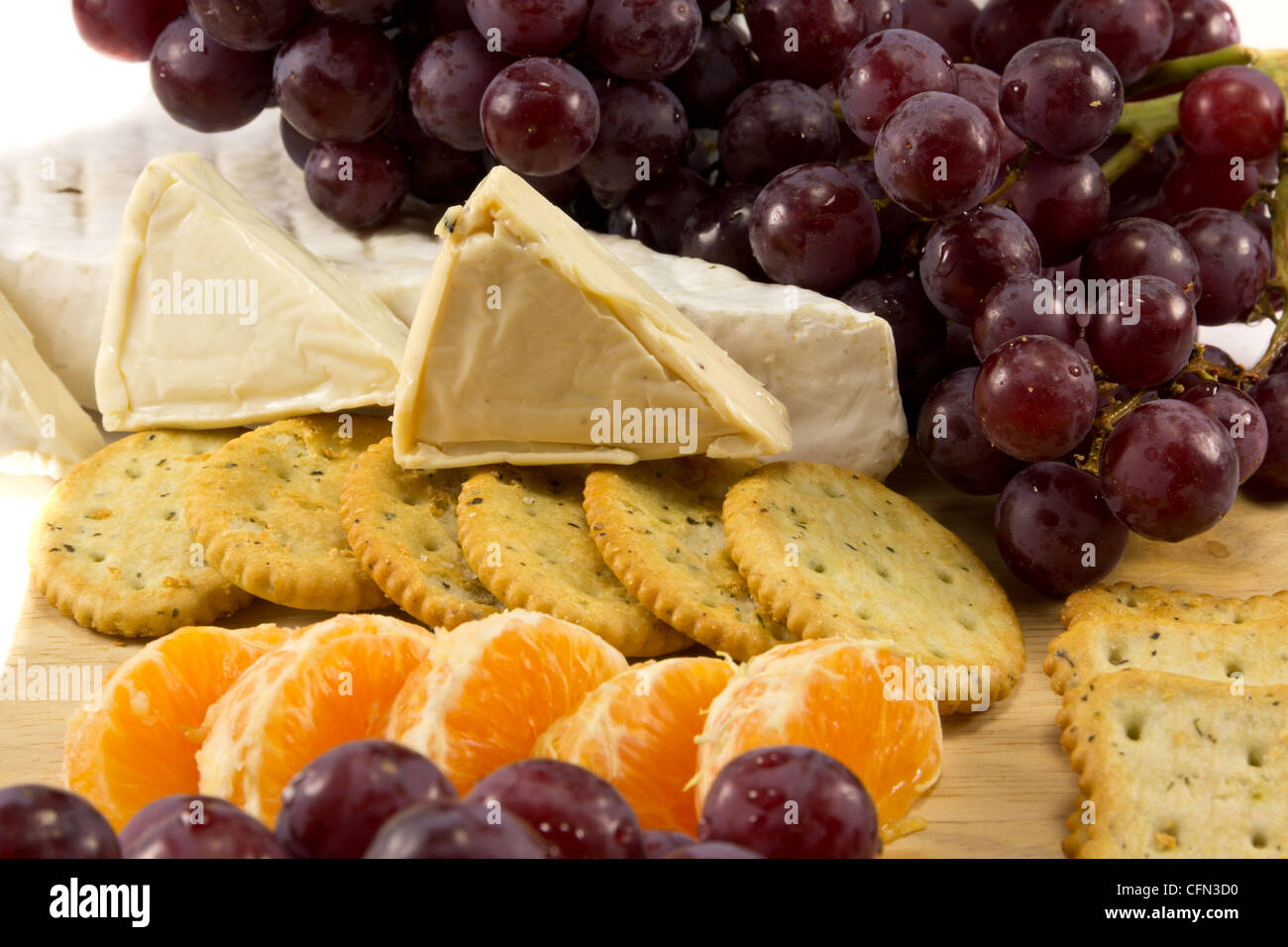 Picture of some grapes brie and some clementins and some cheese Stock ...