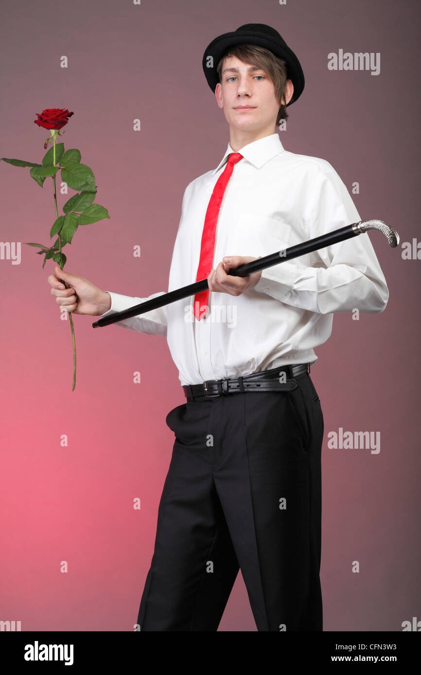 Young men with the red rose on colour background. Love and reflection ...