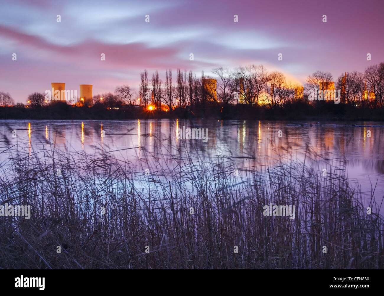 Cooling towers at chemical works reflected in frozen lake (Charlton's ...
