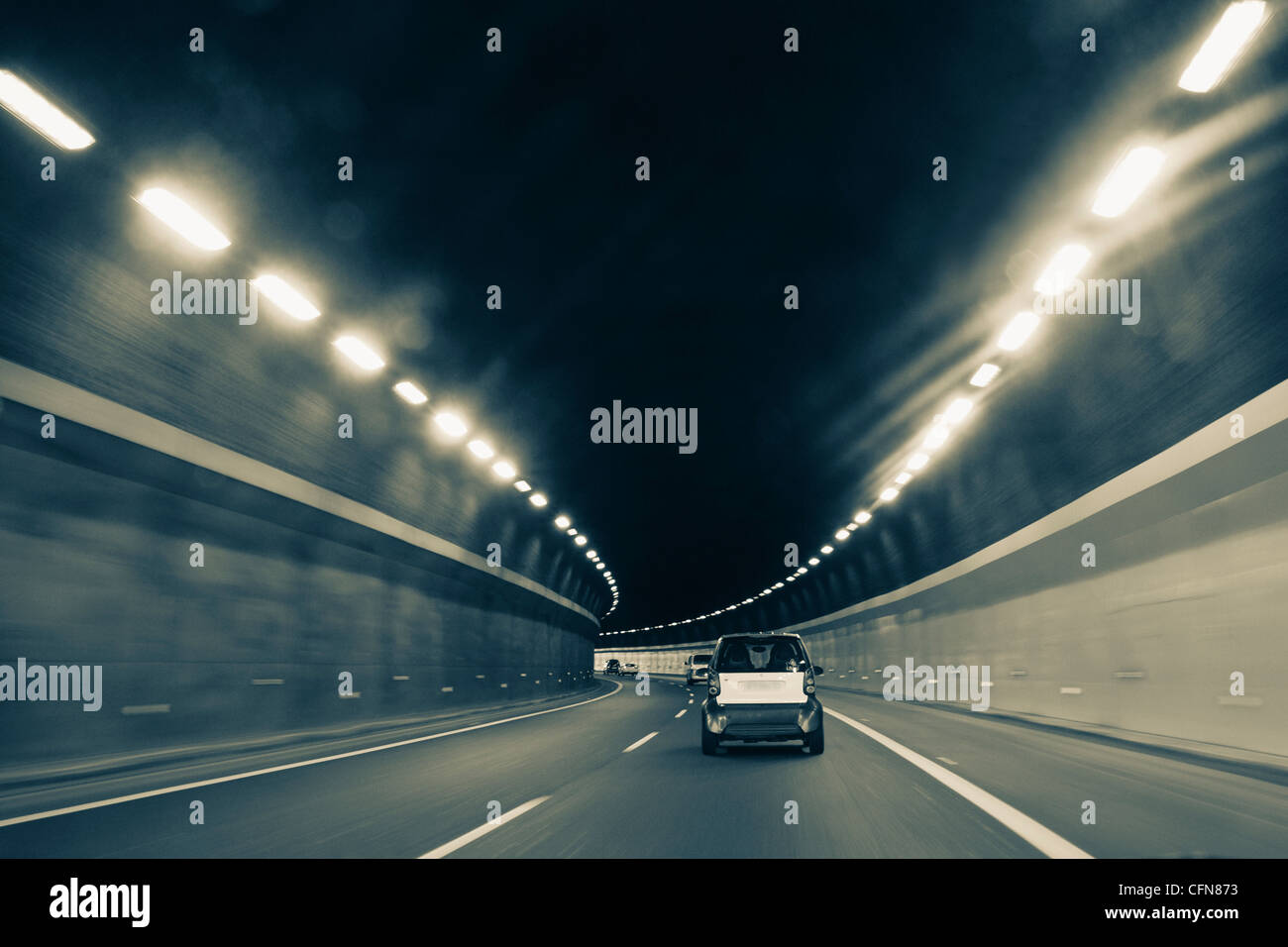 Cars approaching exit of tunnel Stock Photo - Alamy