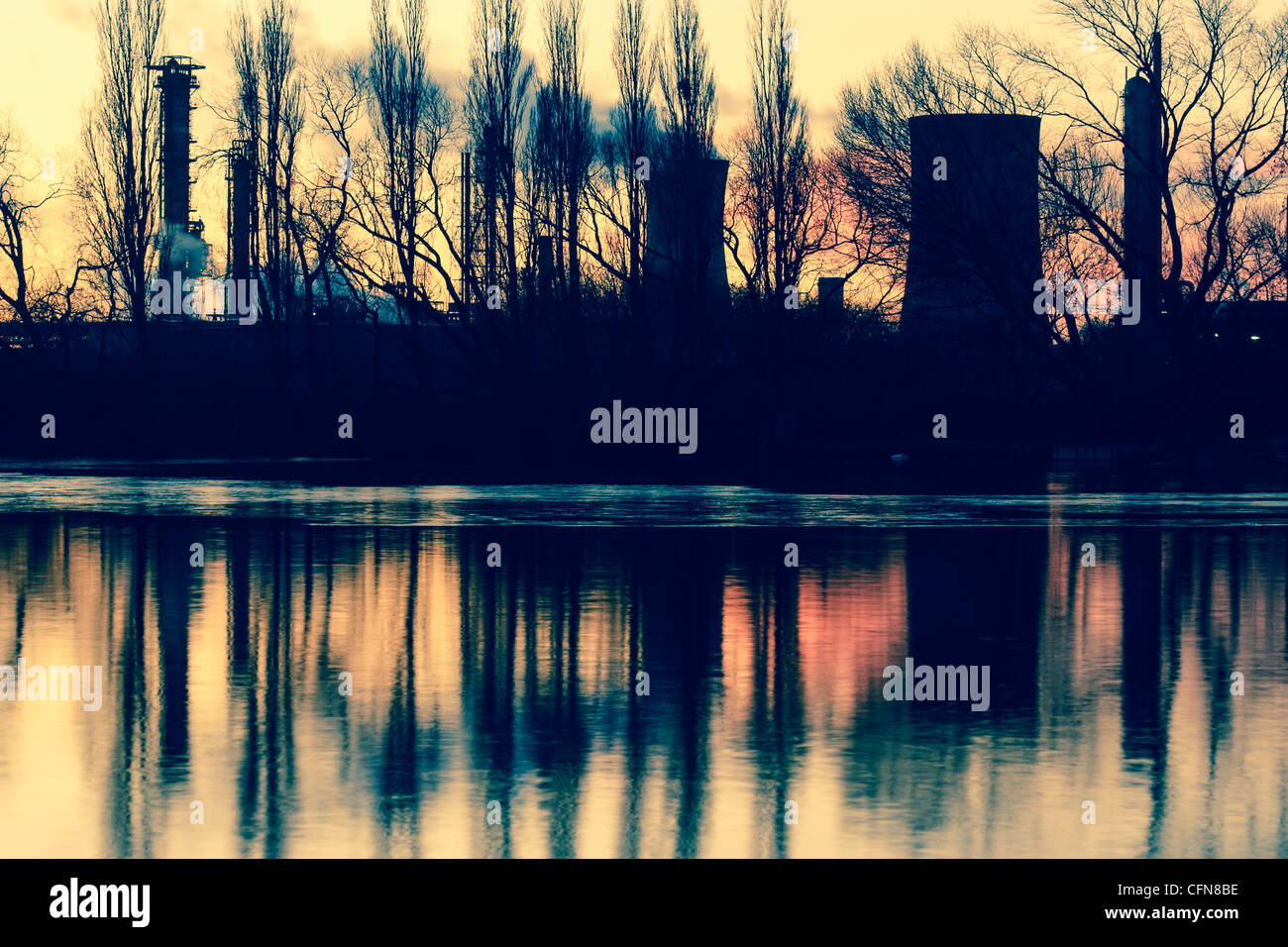 Cooling towers at chemical works reflected in frozen lake (Charlton's ...
