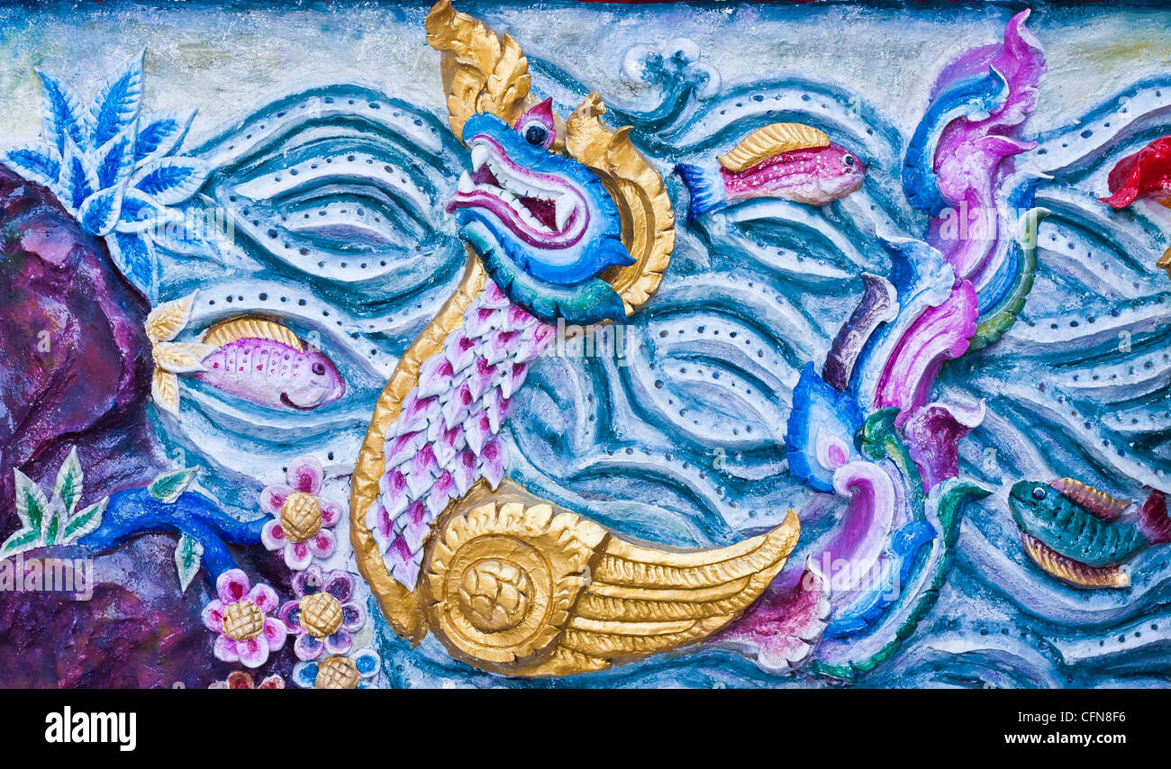 Native art carved on the wall in the temple Stock Photo - Alamy