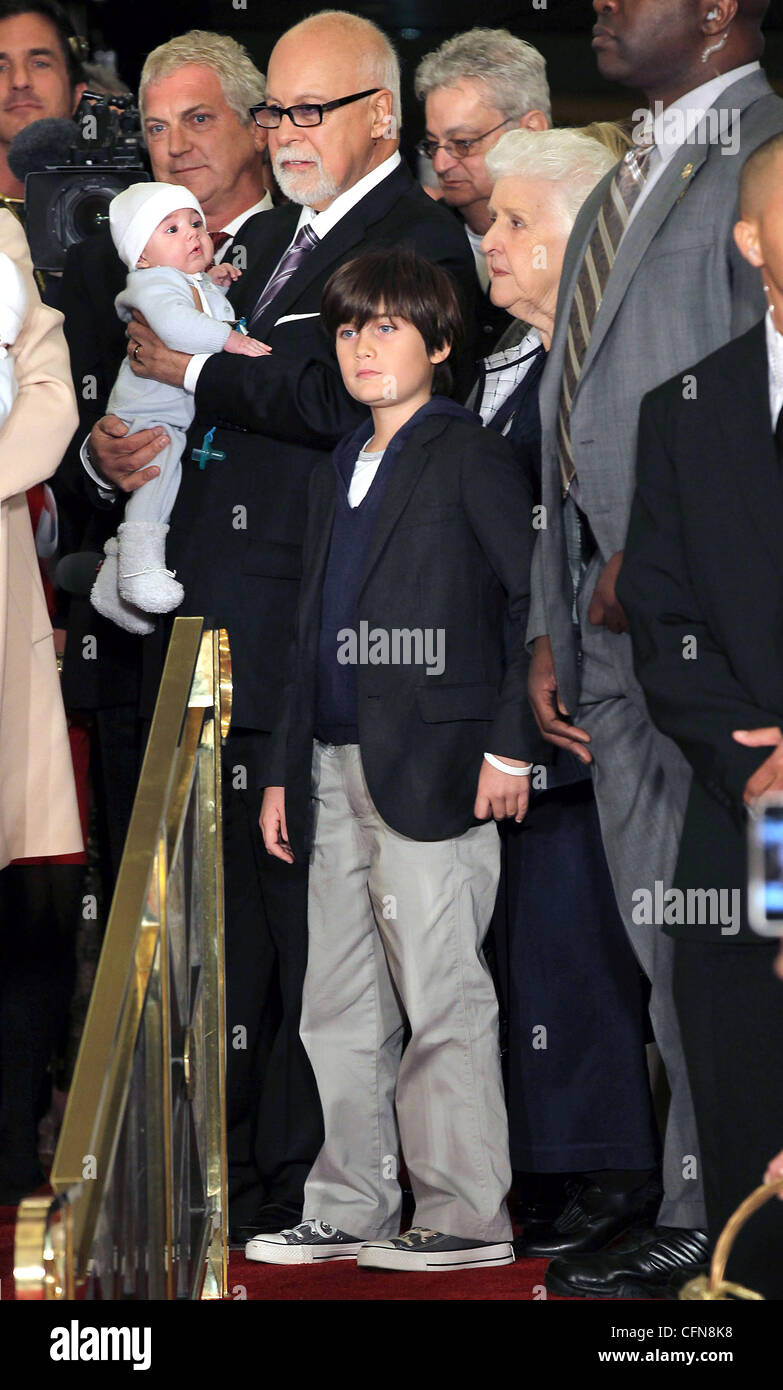 Singer Celine Dion holds her son Nelson Angelil next to her husband and ...
