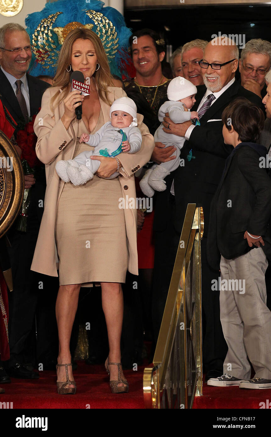 Singer Celine Dion holds her son Nelson Angelil next to her husband and ...